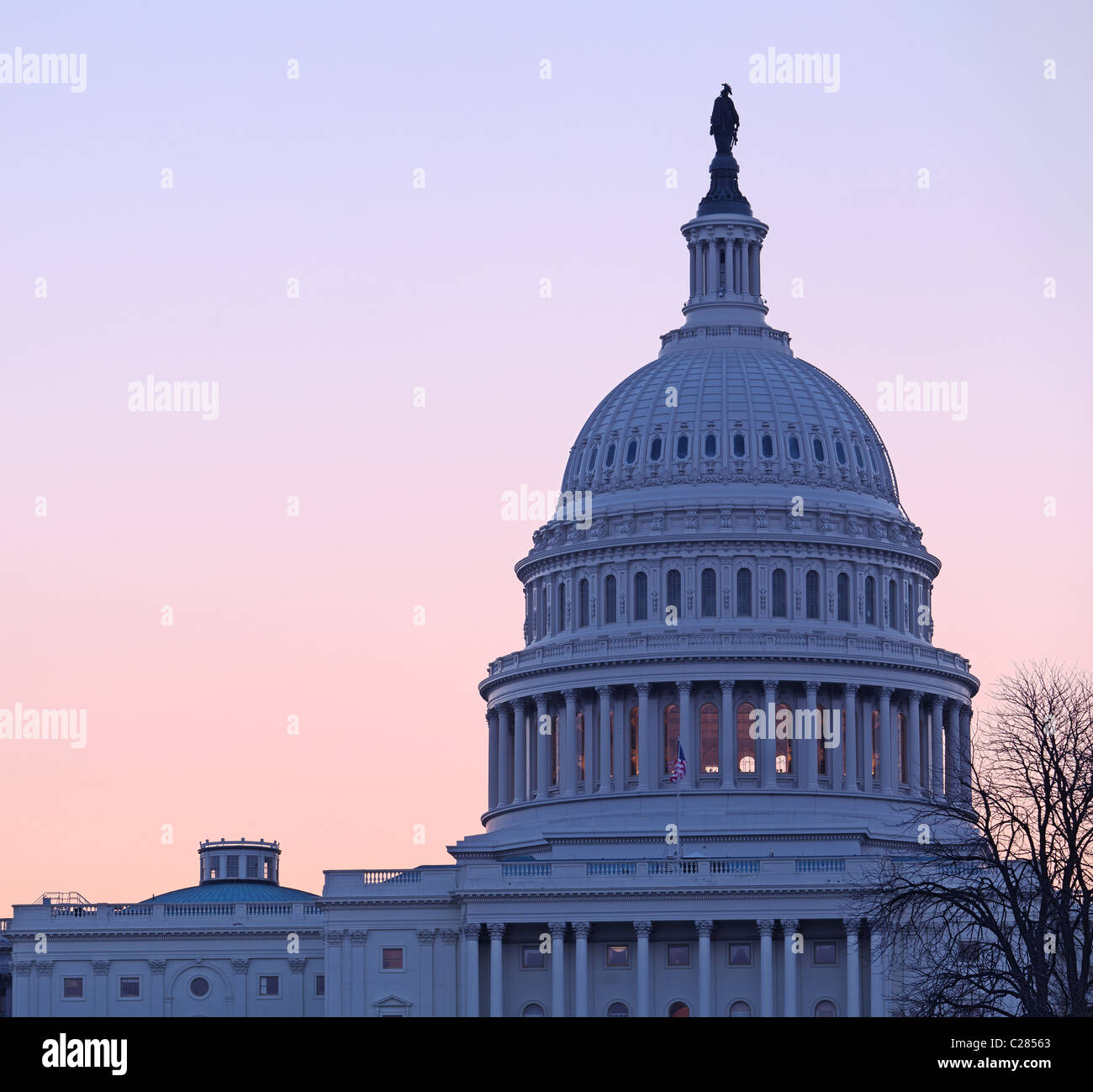 Brightly lit dawn sky behind the illuminated dome of the Capitol in ...