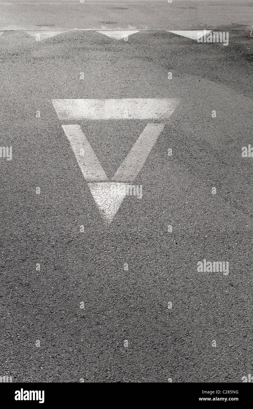 road sign giving precedence painted on the asphalt Stock Photo - Alamy