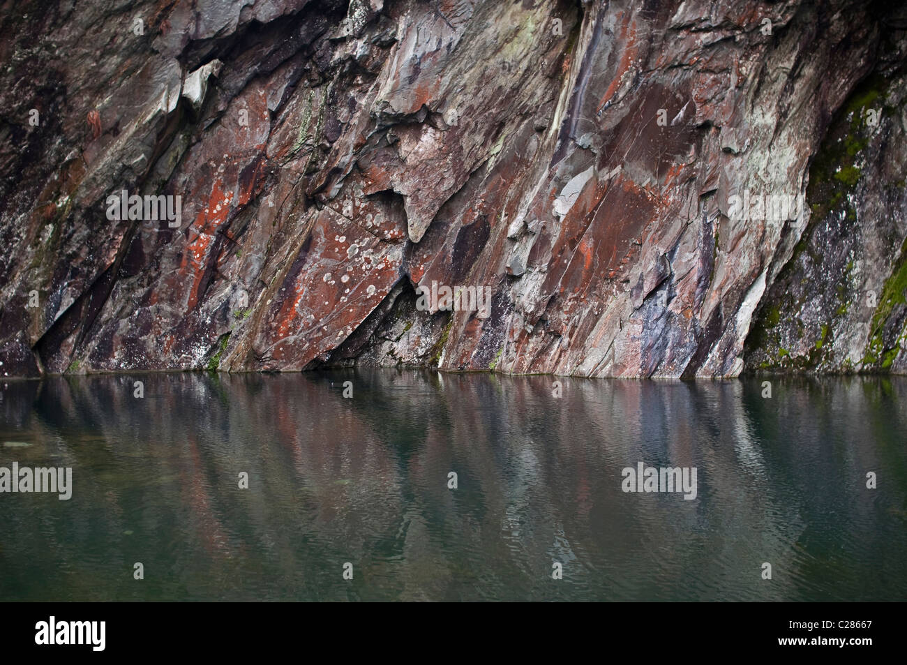 A colorful cliff meets the water in England Stock Photo - Alamy