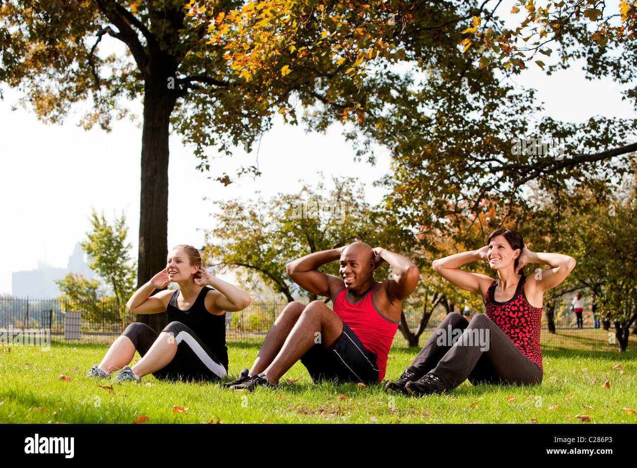 A group of people doing exercises in the park Stock Photo - Alamy