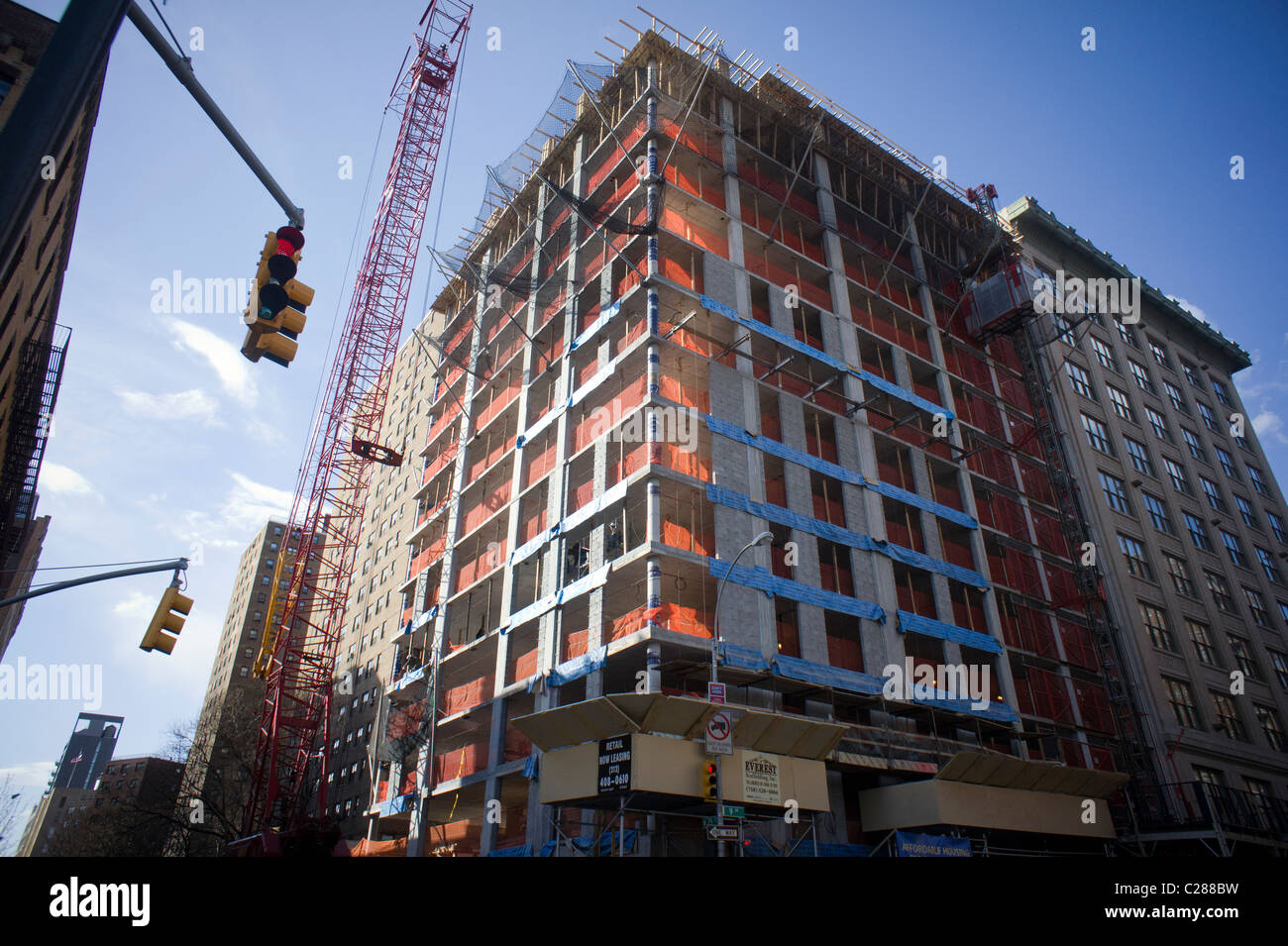 Construction workers building an affordable housing apartment building ...