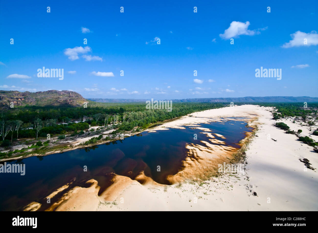 A wide sandy floodplain where a river ends in the dry season drought ...