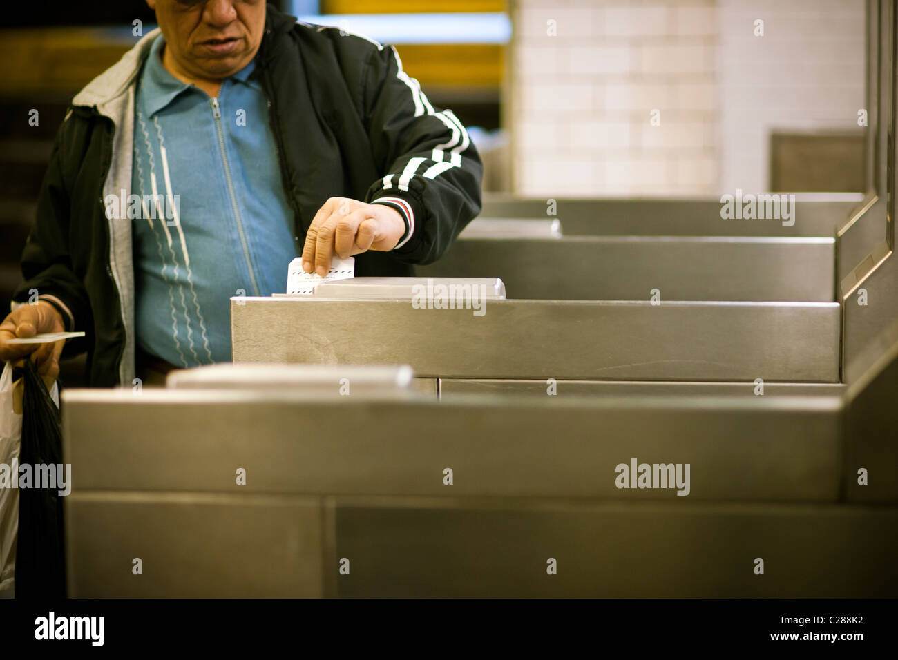 Straphangers swipe their Metrocards in the subway at the 23rd Street ...