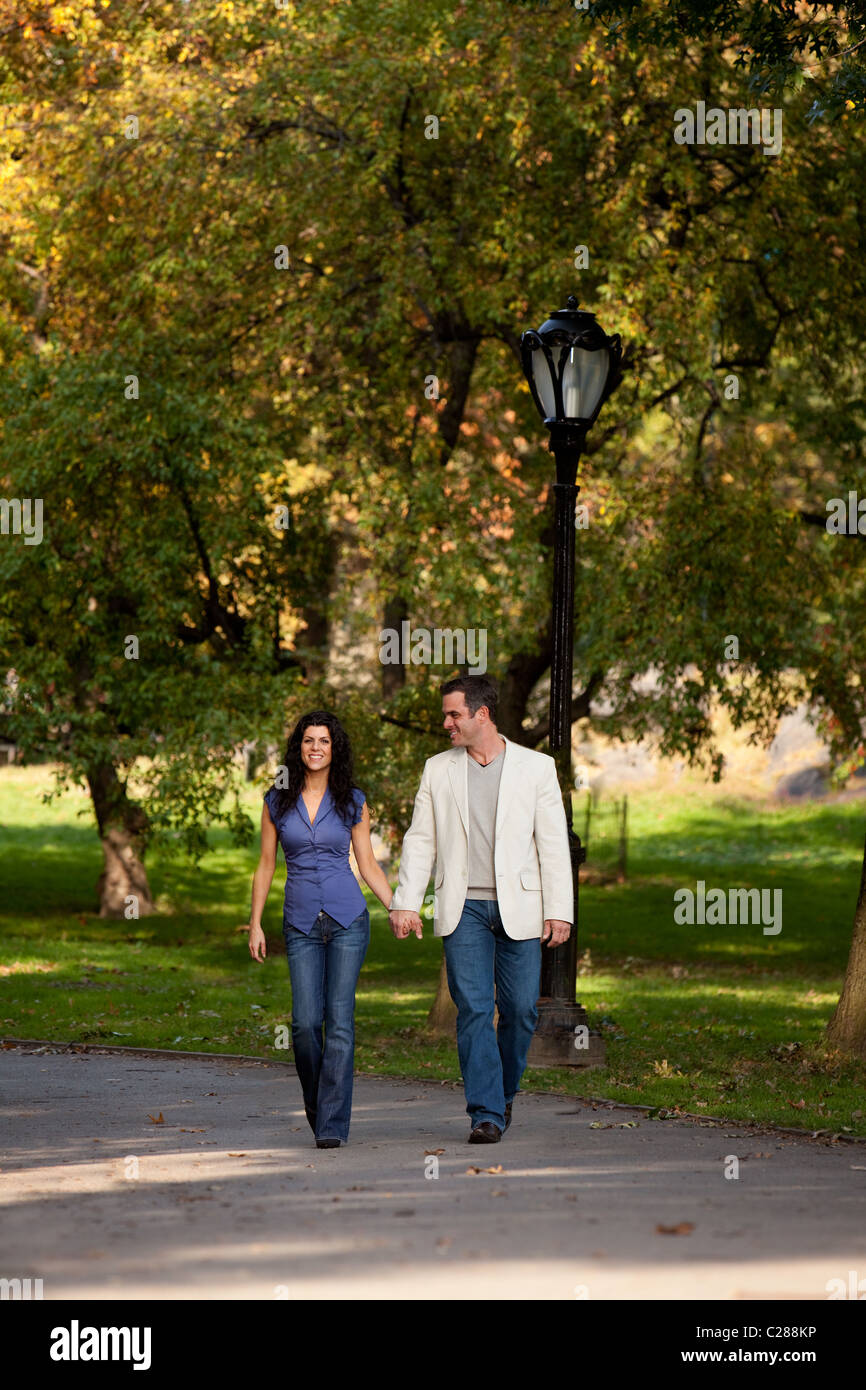 A happy couple walking in the park Stock Photo - Alamy