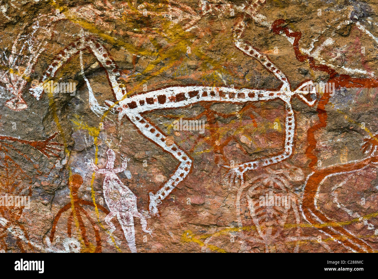 Aboriginal rock art depicts figures of Mimi Spirits on a cave wall ...