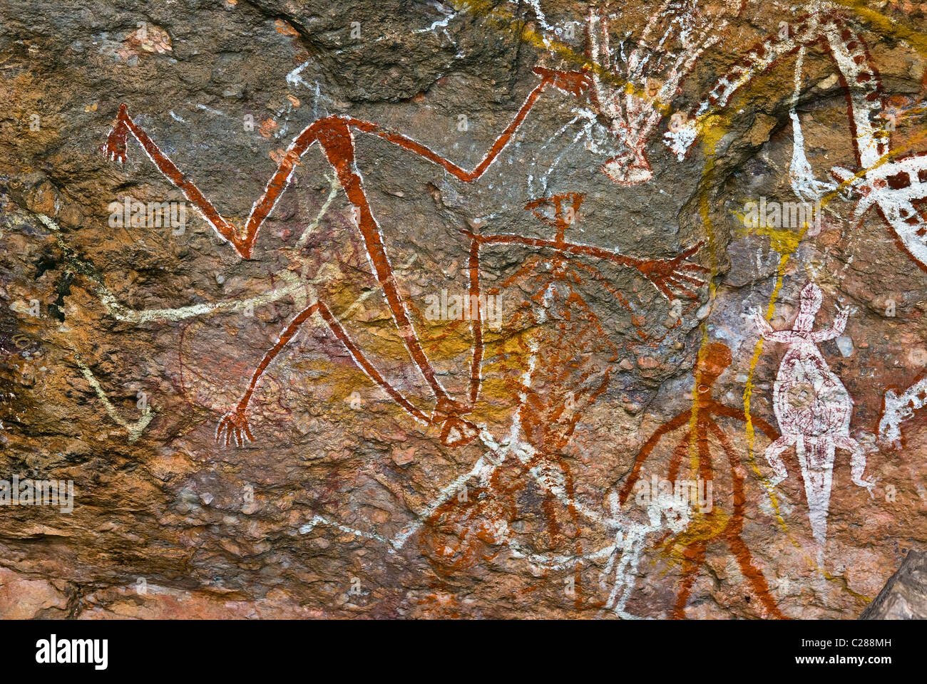 Aboriginal rock art depicts figures of Mimi Spirits on a cave wall ...