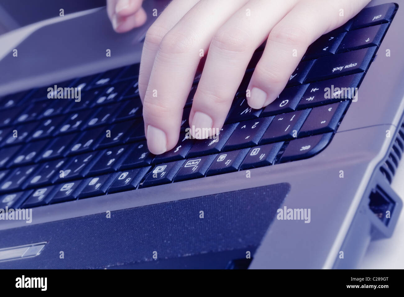Typing on laptop Stock Photo - Alamy