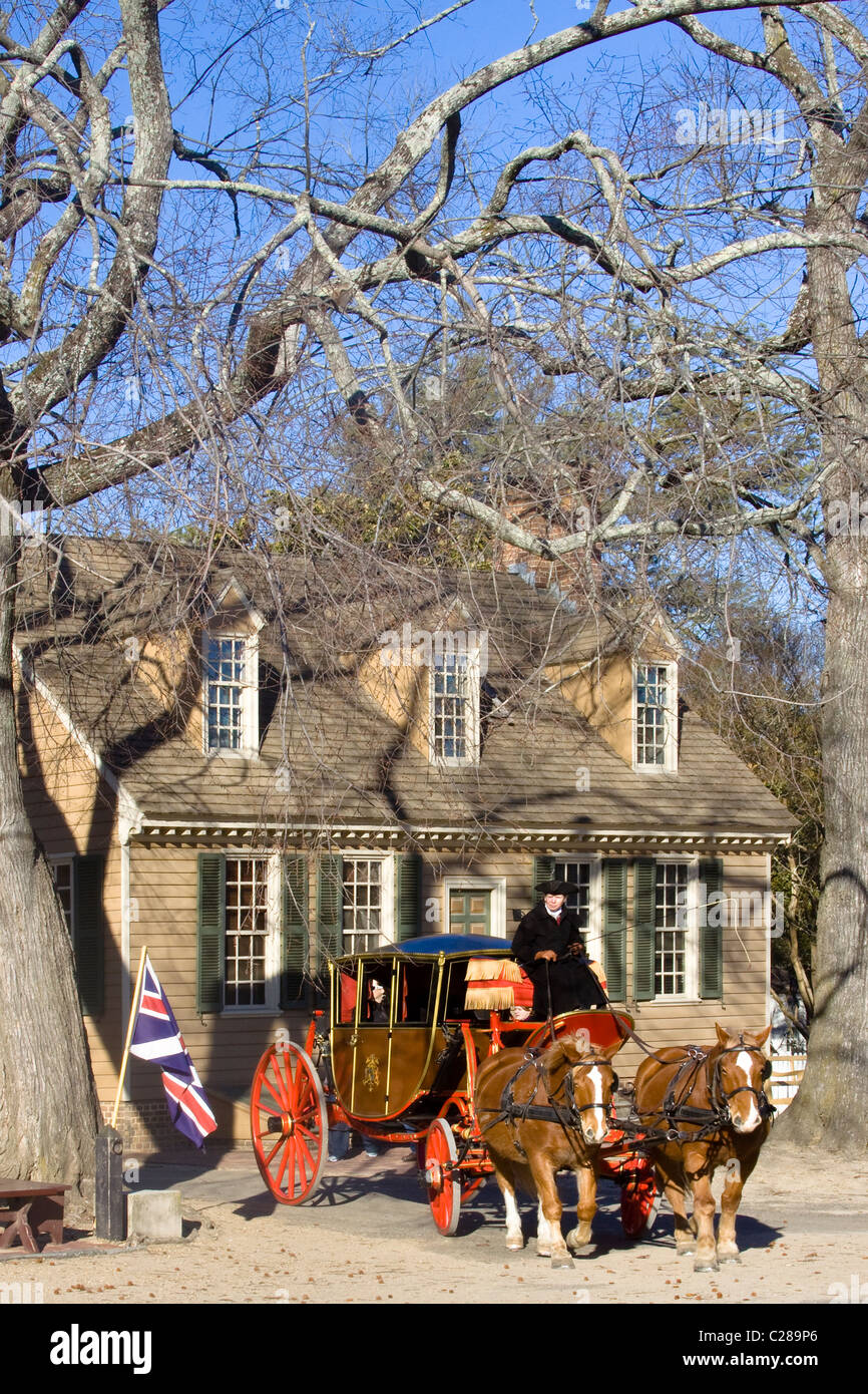 Colonial coachman with driving whip on a horse and carriage - historic ...