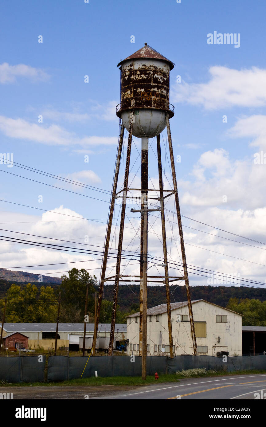 Rusty water tower and yellow warehouse along Henry W. Miller Highway ...