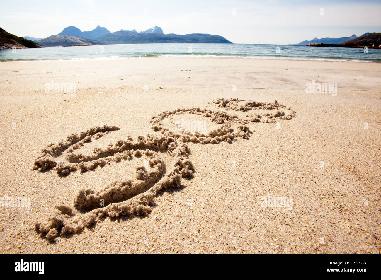 An S.O.S. message in the sand on an island Stock Photo - Alamy