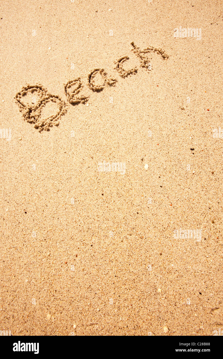 Beach written in the sand on the coast Stock Photo - Alamy