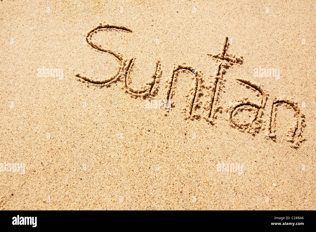 The word suntan written in the sand on a beach Stock Photo - Alamy