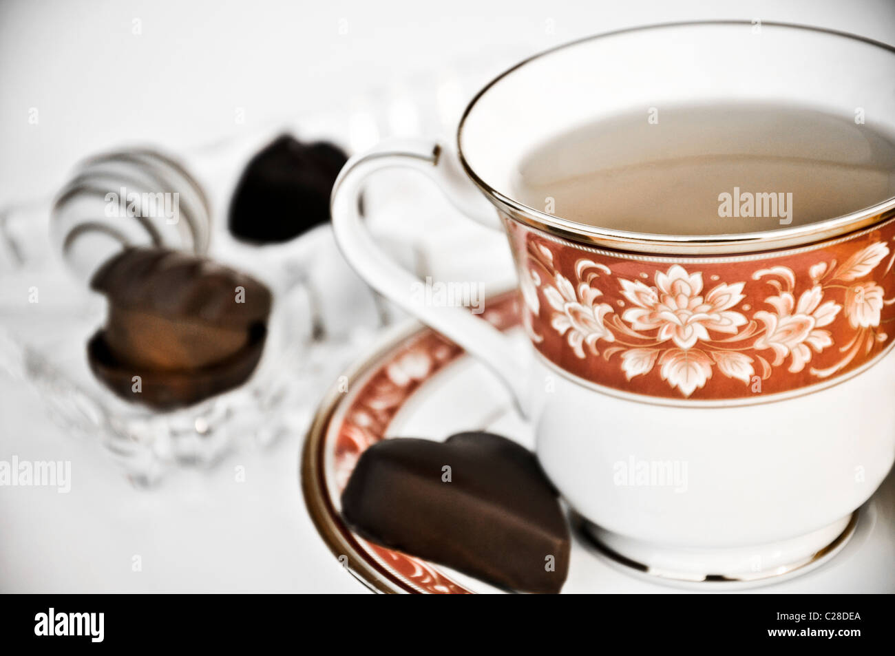 Classy porcelain cup of tea and chocolates - vintage abstract look ...
