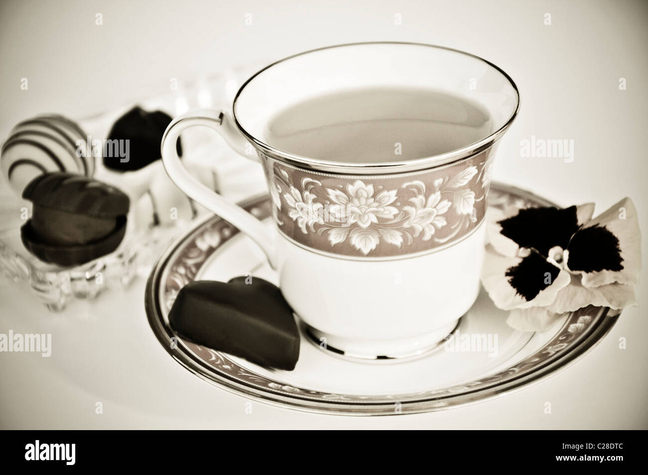 Classy porcelain cup of tea and chocolates - vintage abstract look ...