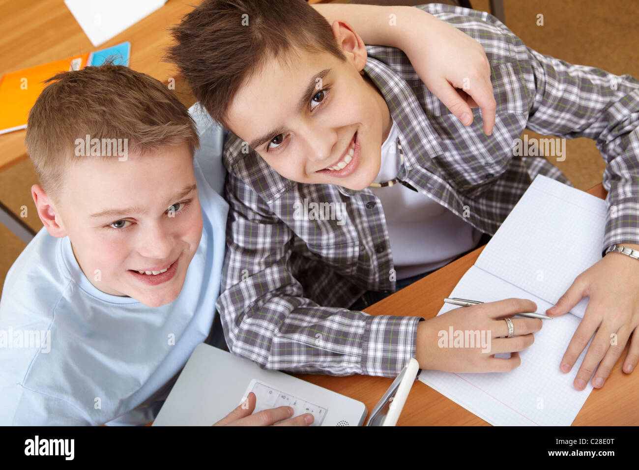 Portrait of smart teenage guys looking at camera at lesson Stock Photo ...