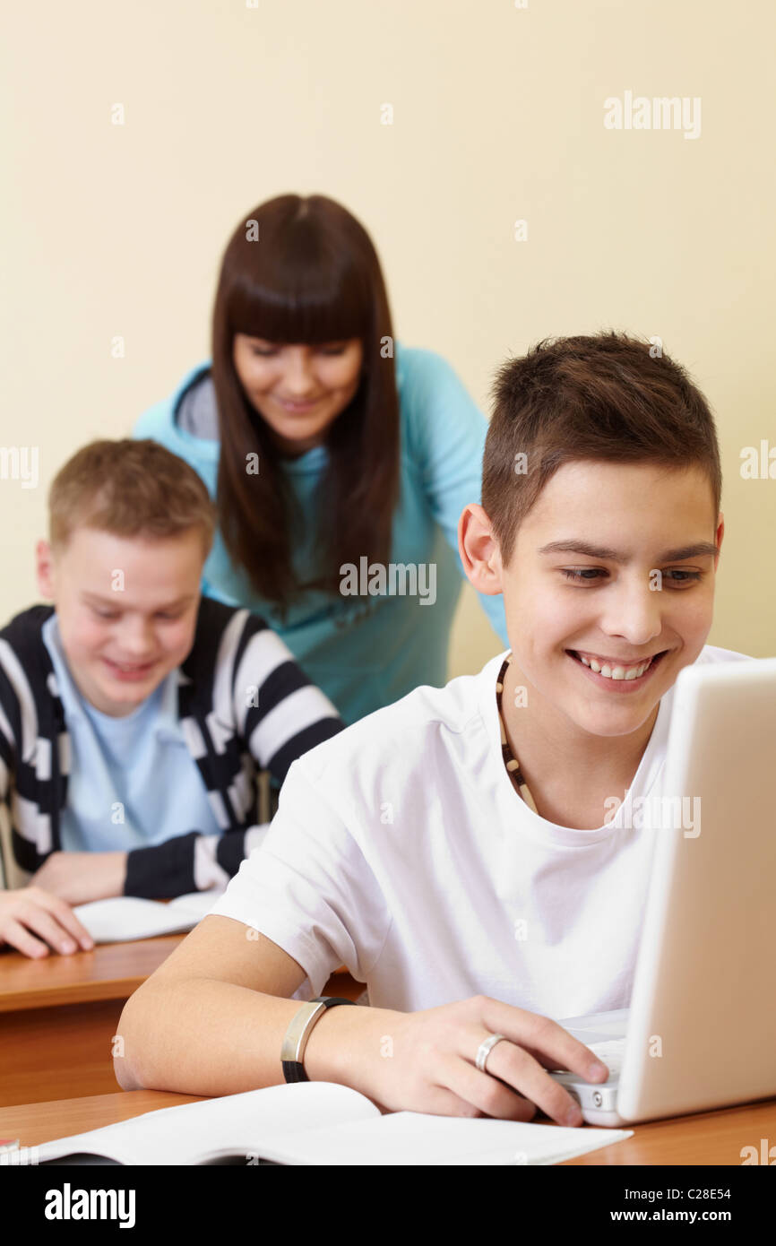 Portrait of smart lad working with laptop during lesson Stock Photo - Alamy