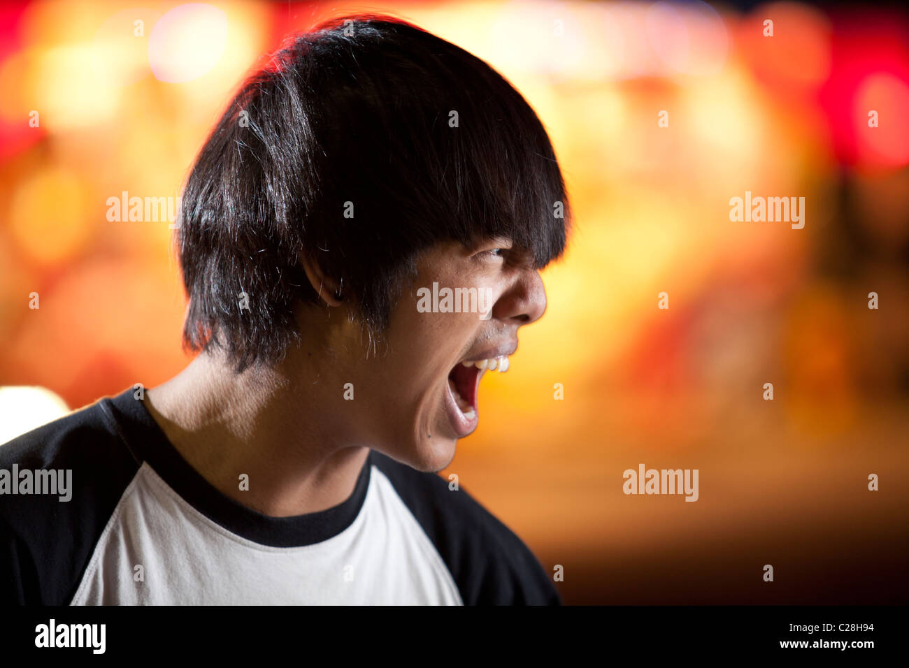 Thai boy yell on orange background , Lampang, Thailand Stock Photo - Alamy