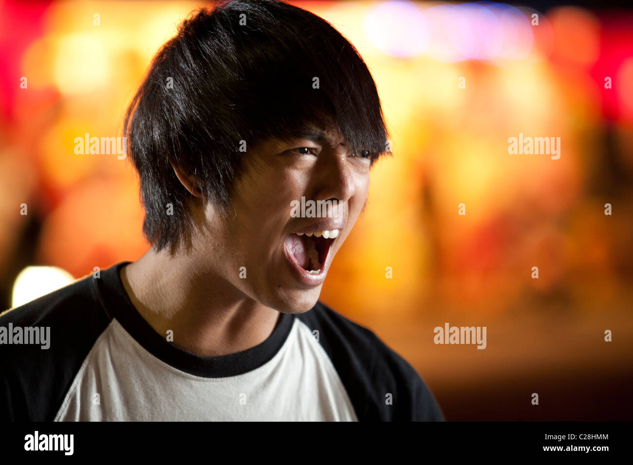Thai boy yell on orange background , Lampang, Thailand Stock Photo - Alamy