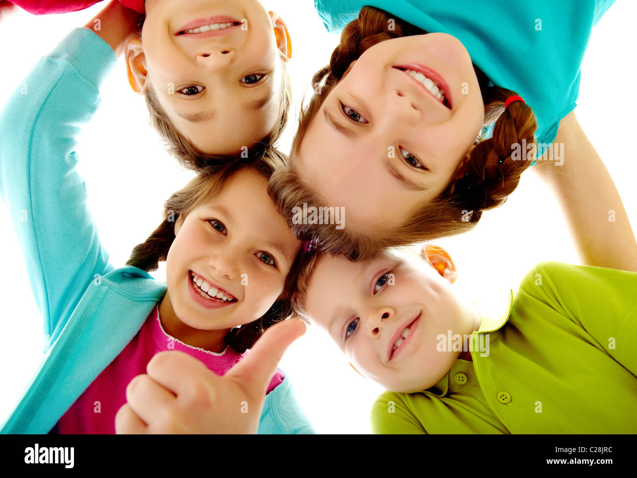Photo of joyful children touching by their heads with girl her thumb up ...
