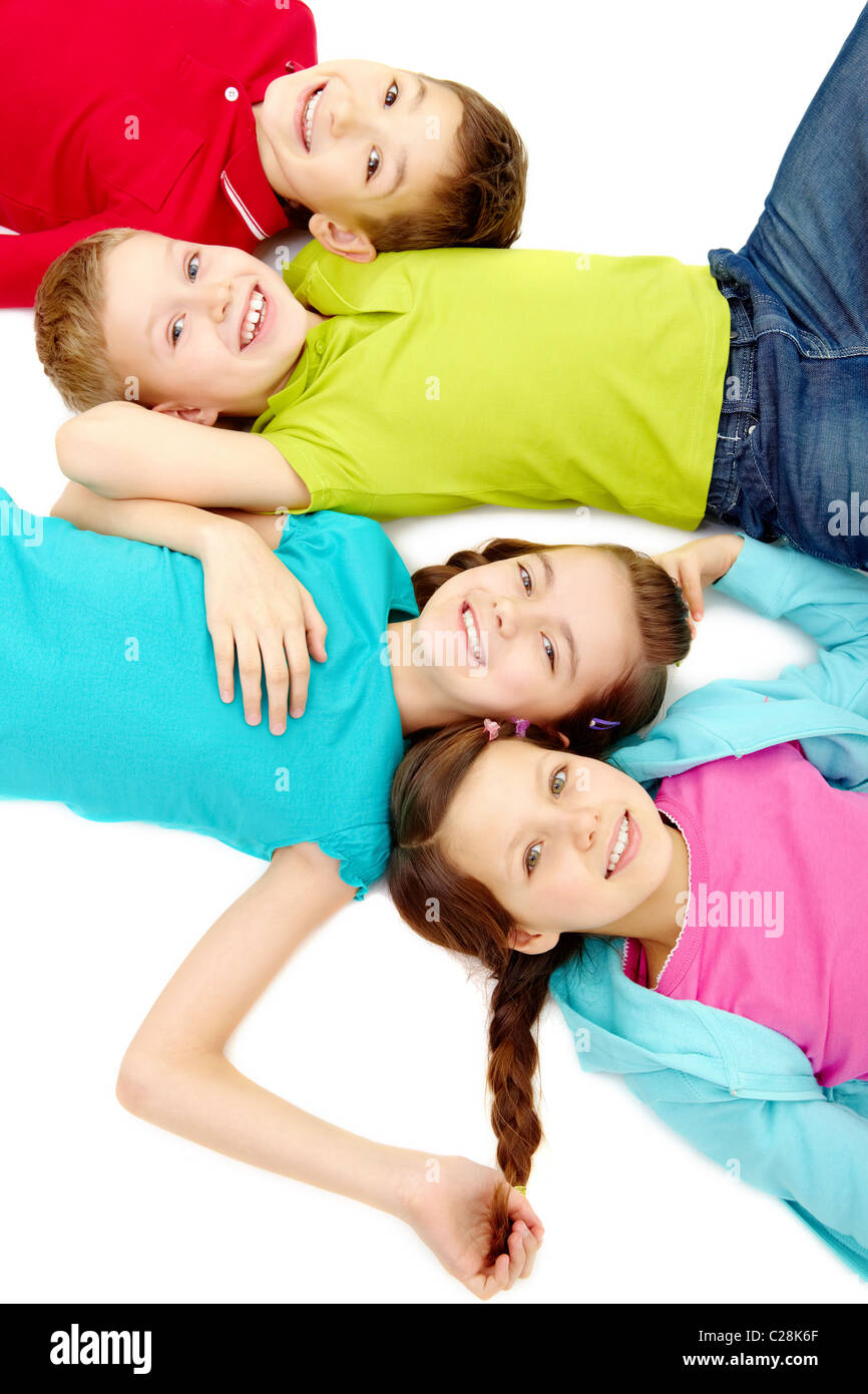 Group of happy small friends lying in line Stock Photo - Alamy