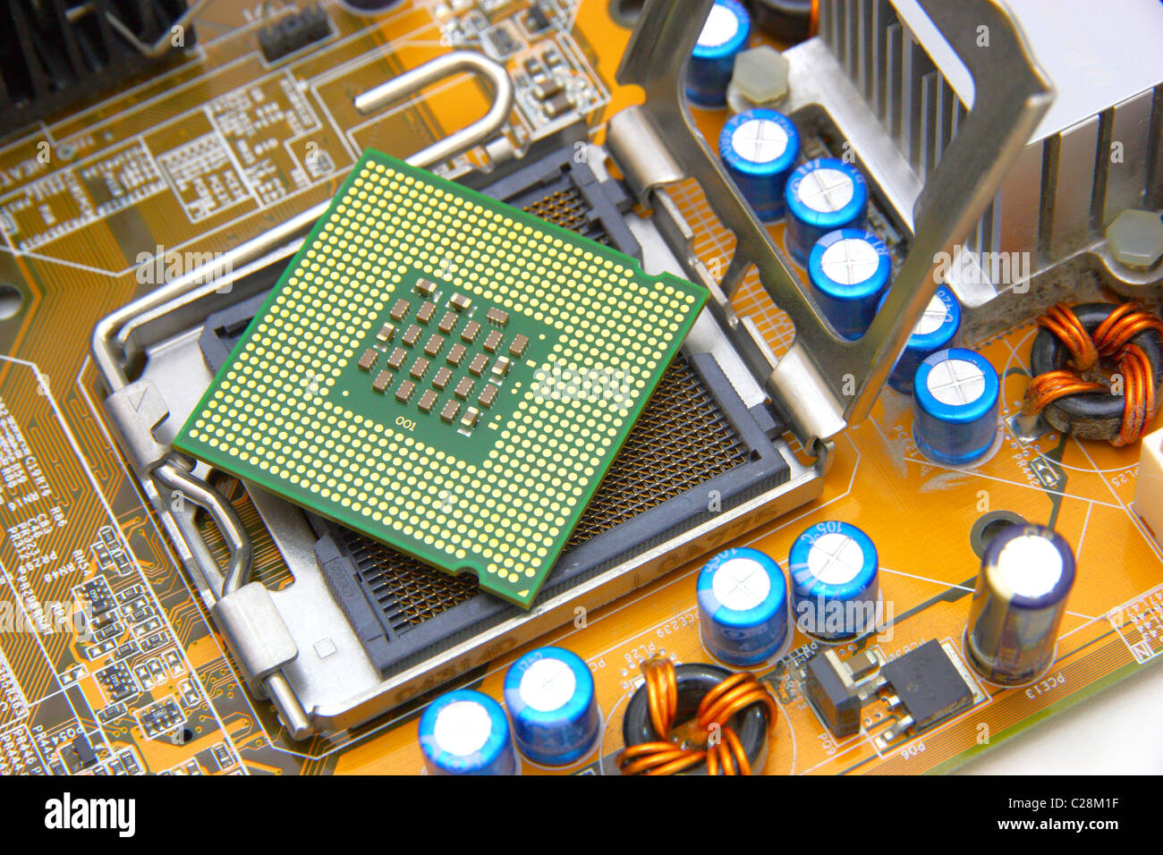 Processor on the yellow computer motherboard Stock Photo - Alamy
