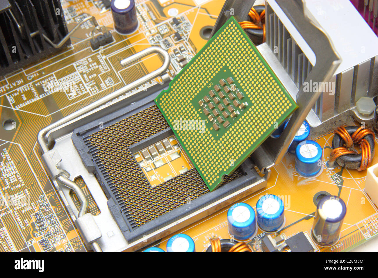 Processor on the yellow computer motherboard Stock Photo - Alamy