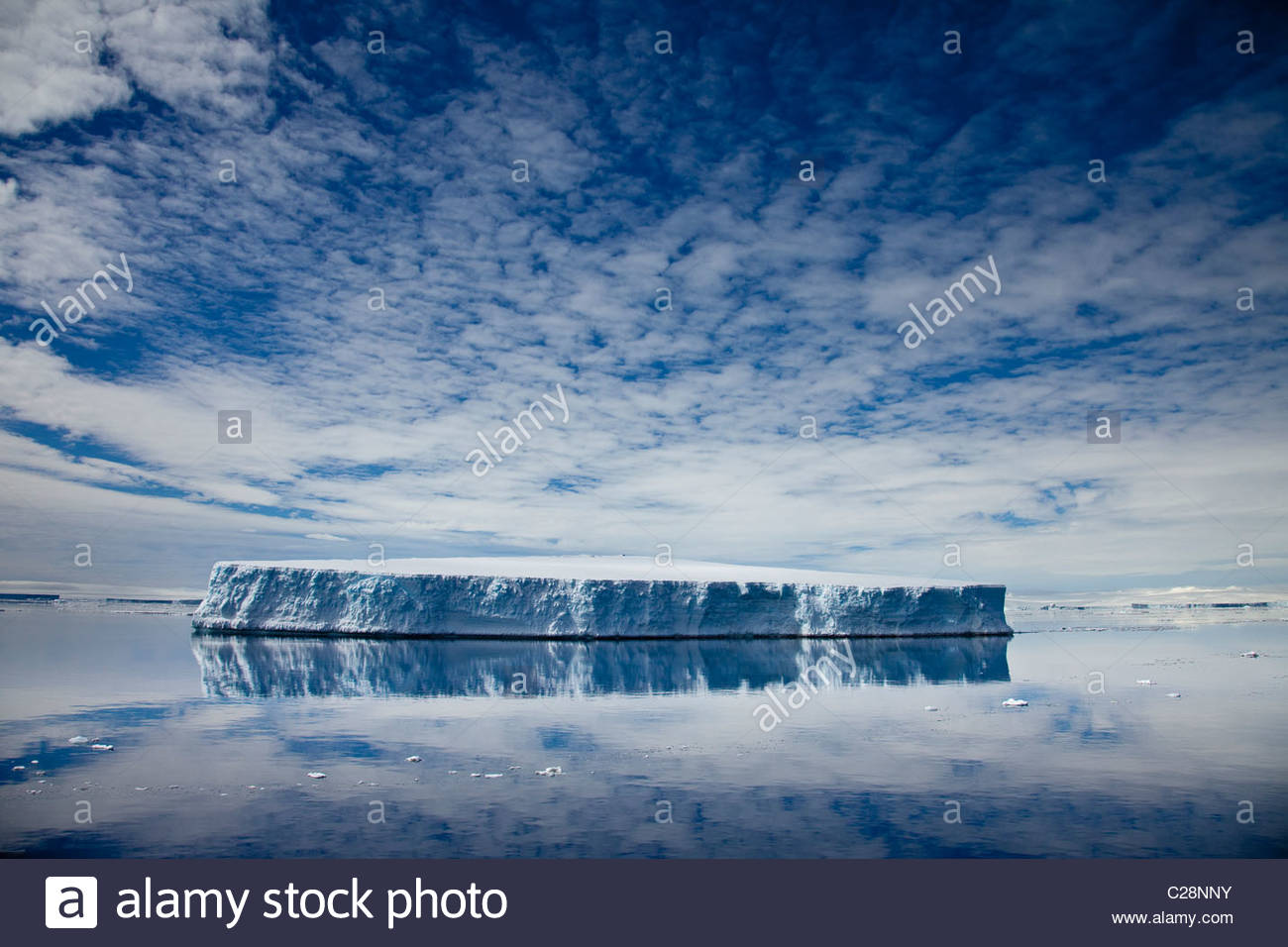 Tabular iceberg reflected in still water Stock Photo - Alamy