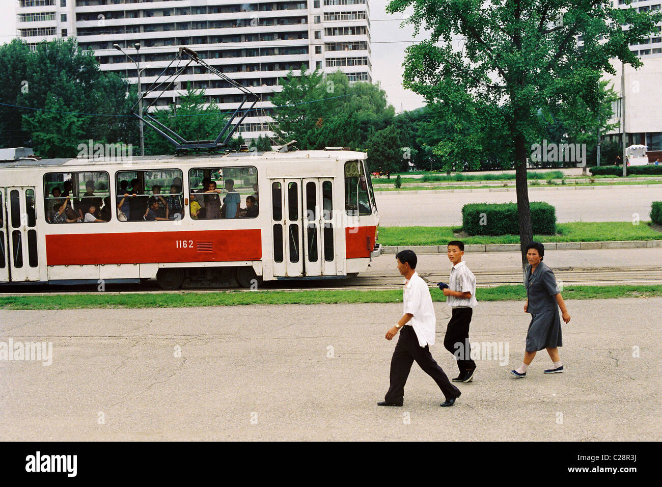 North Korea: Pyongyang, passers-by and tram in the background, 2009 ...