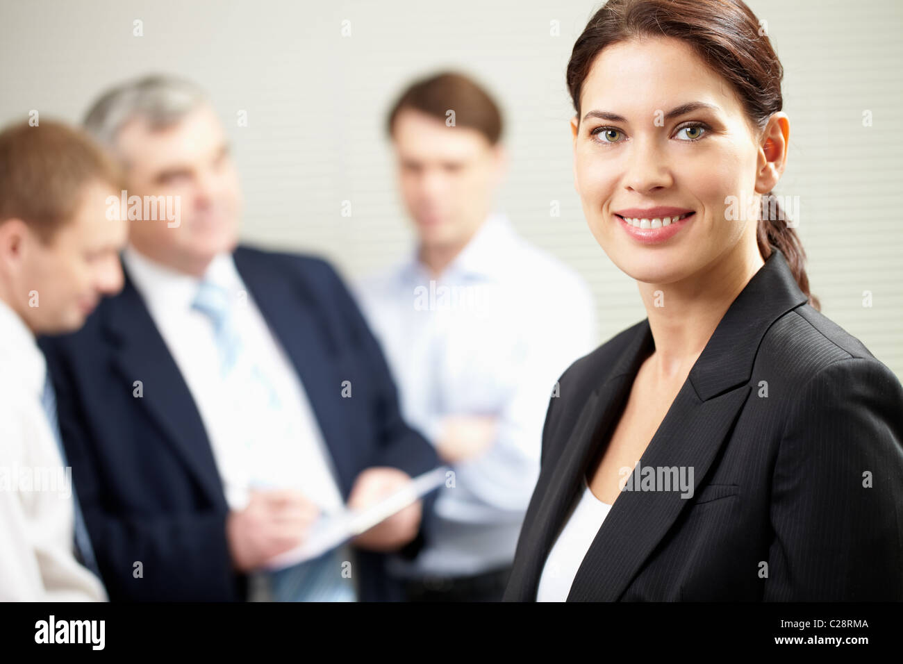 A beautiful businesswoman against her colleagues Stock Photo - Alamy A beautiful businesswoman against her colleagues Stock Photo - Alamy
