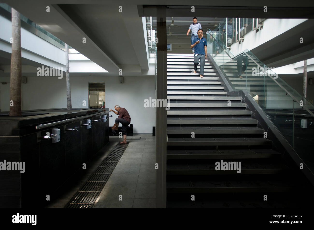 Men perform ablutions before prayers at the Assyafaah Mosque in ...