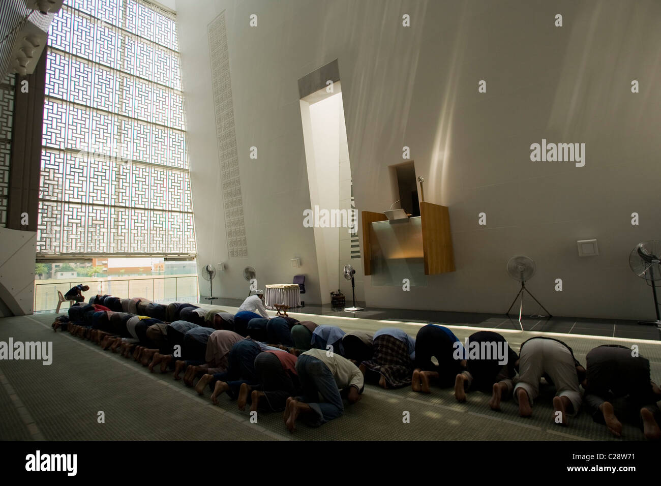 Men pray in the main prayer hall at the Assyafaah Mosque in Singapore ...