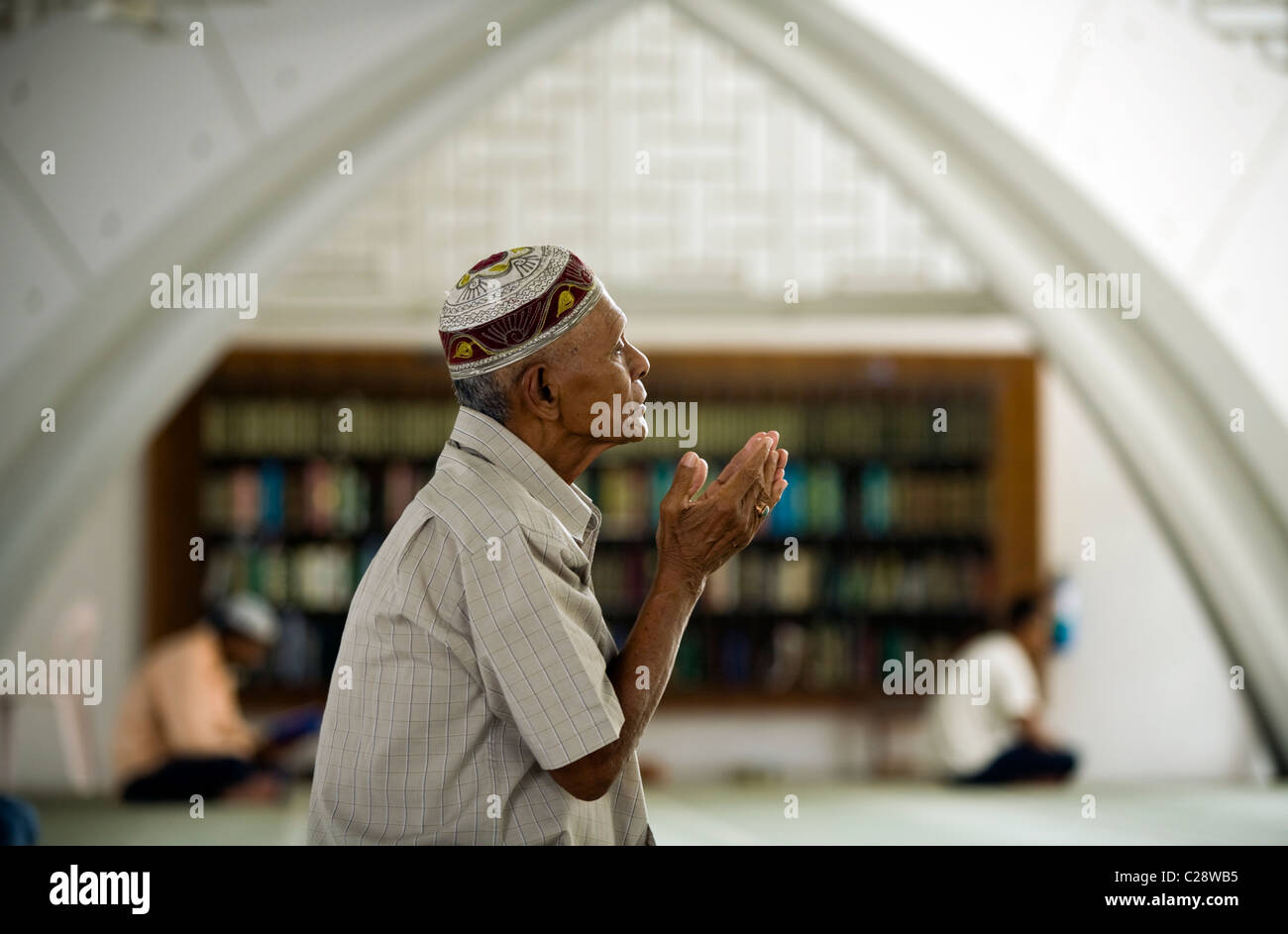 A man prays in the main prayer hall at the Assyafaah Mosque in ...