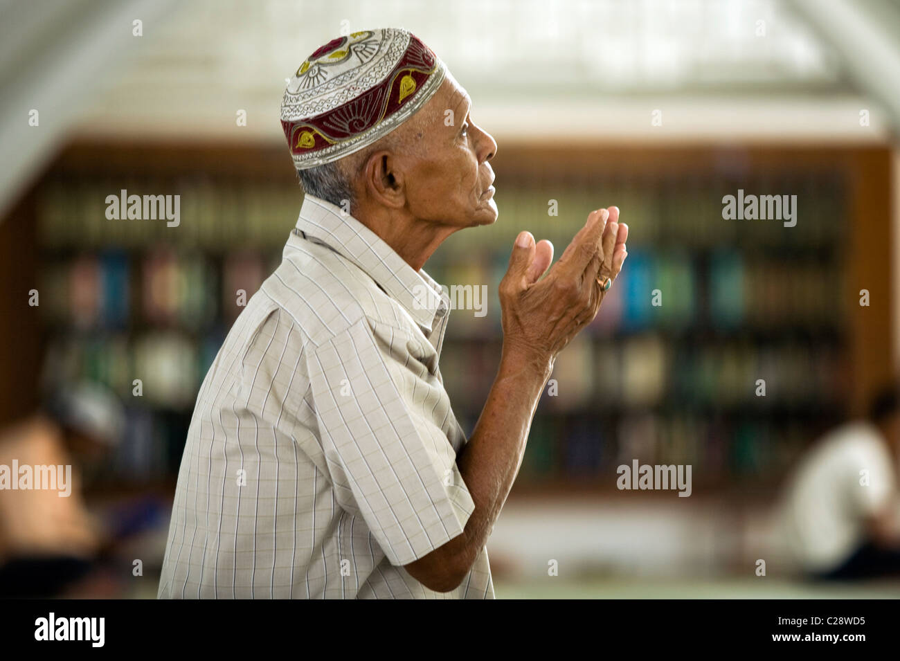 A man prays in the main prayer hall at the Assyafaah Mosque in ...