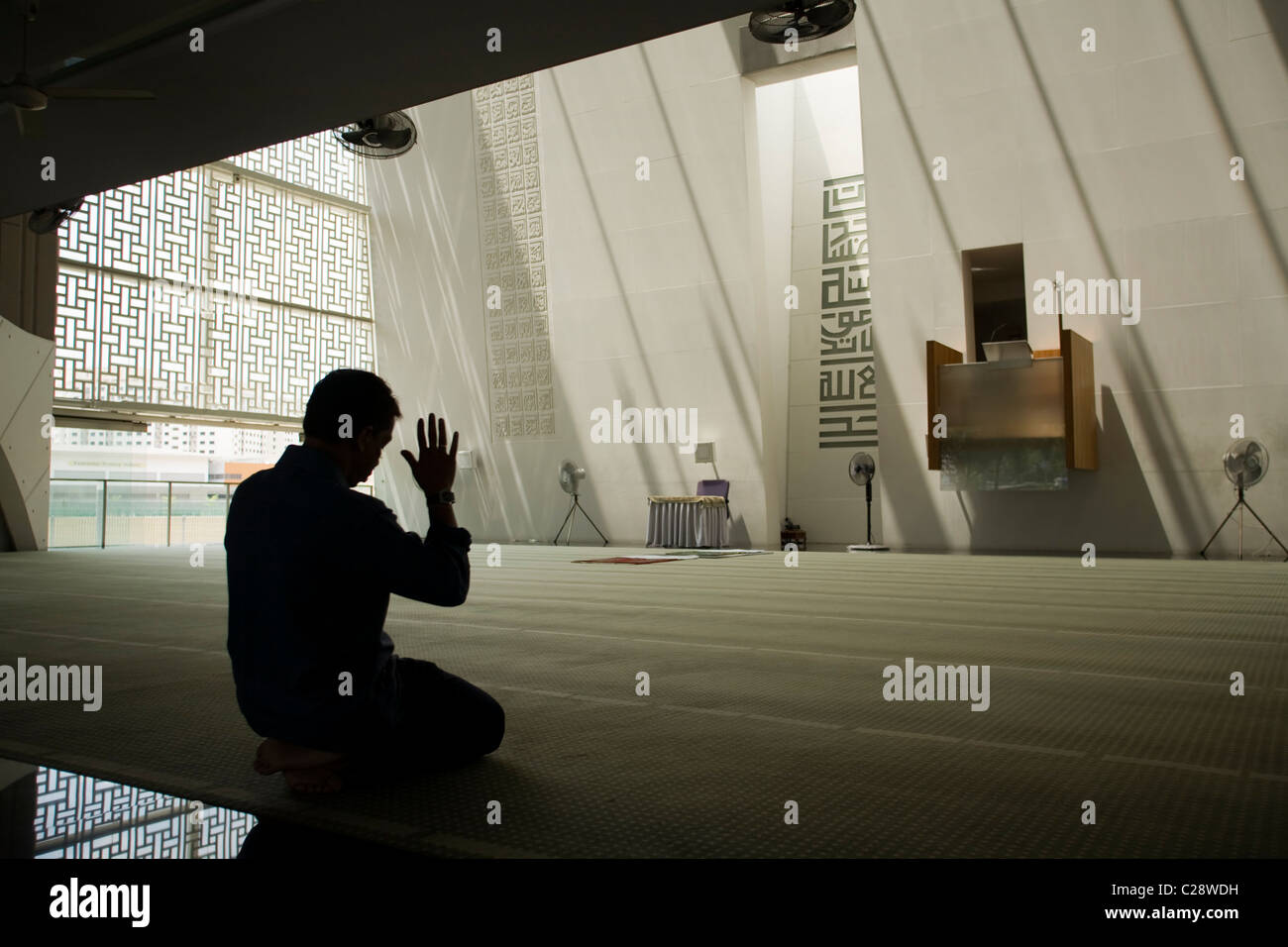 A man prays in the main prayer hall at the Assyafaah Mosque in ...
