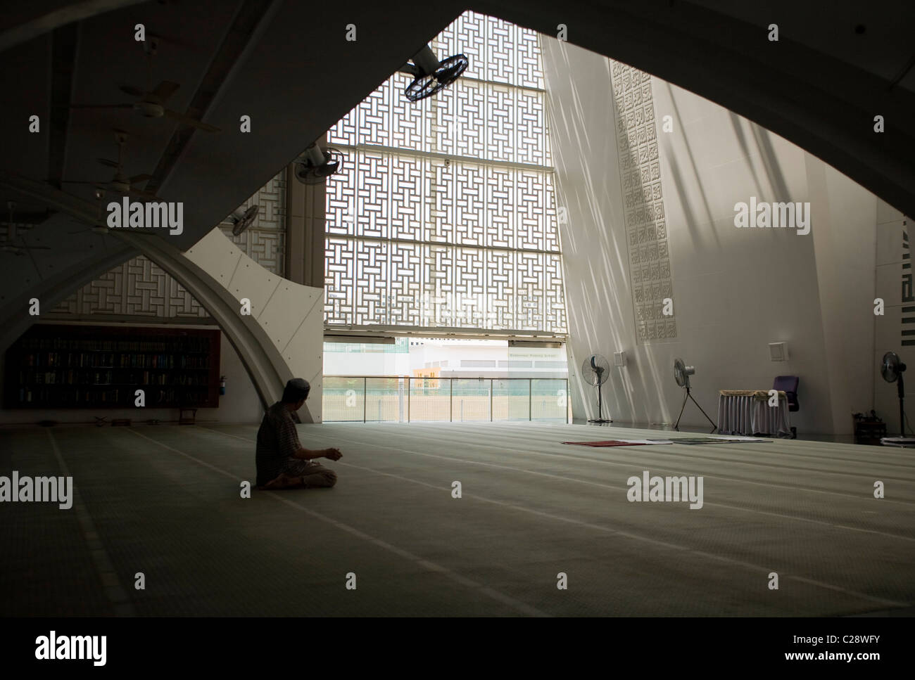 A man prays in the main prayer hall at the Assyafaah Mosque in ...