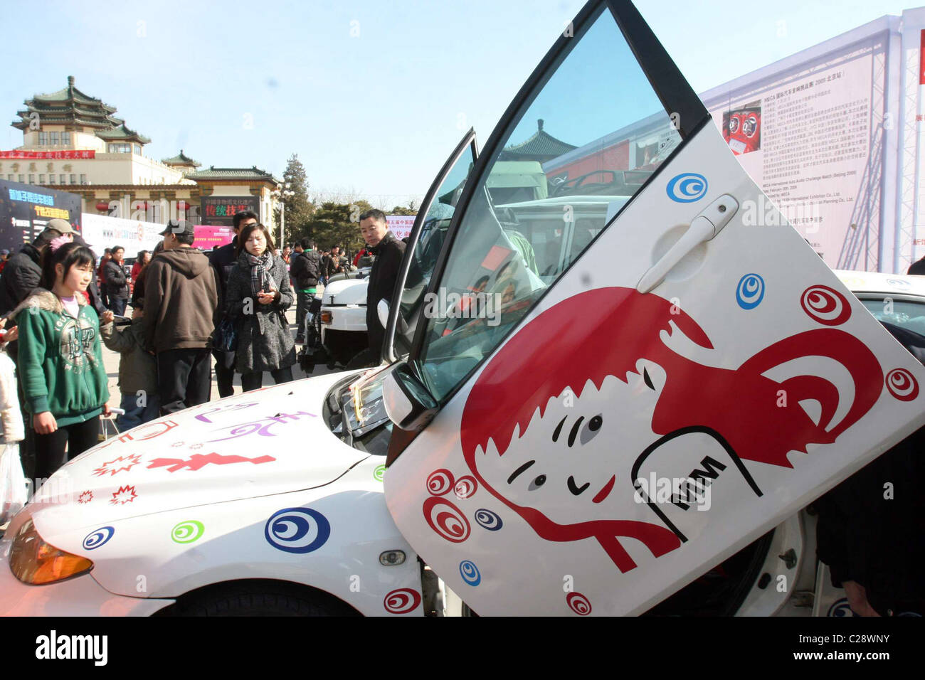 Petrol-heads admire a display of modified cars in Beijing, China ...