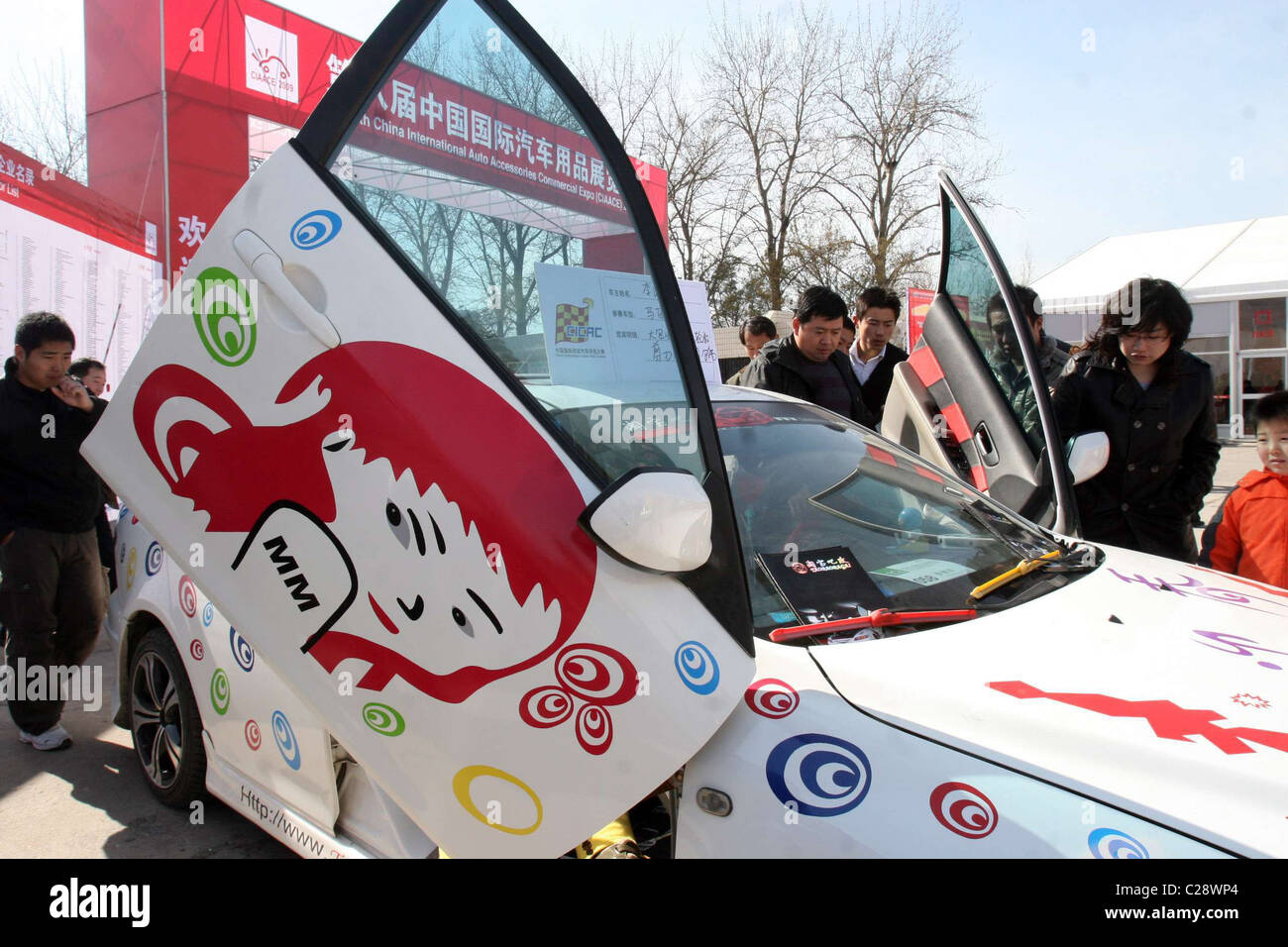 Petrol-heads admire a display of modified cars in Beijing, China ...