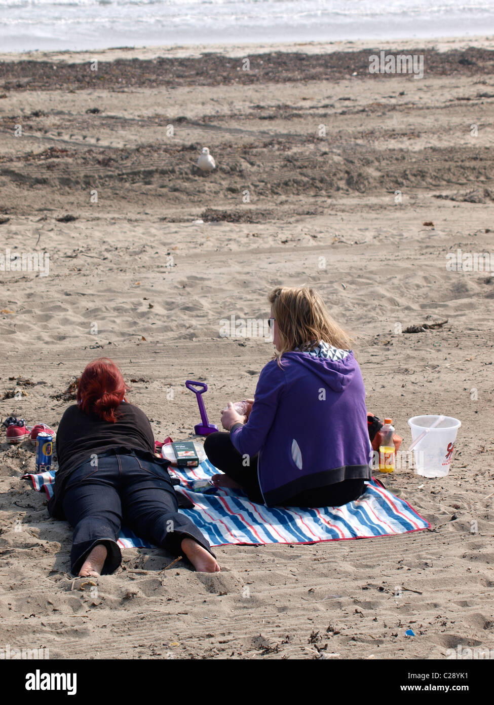 Two women at the beach, UK Stock Photo - Alamy