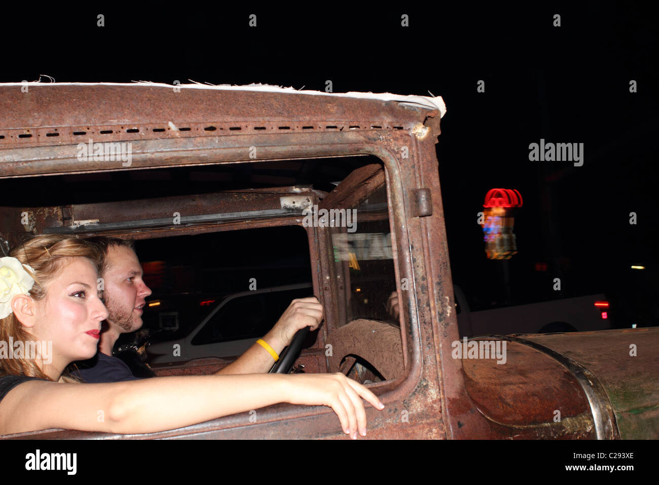 Couple driving in hot rod in Austin Texas Stock Photo - Alamy
