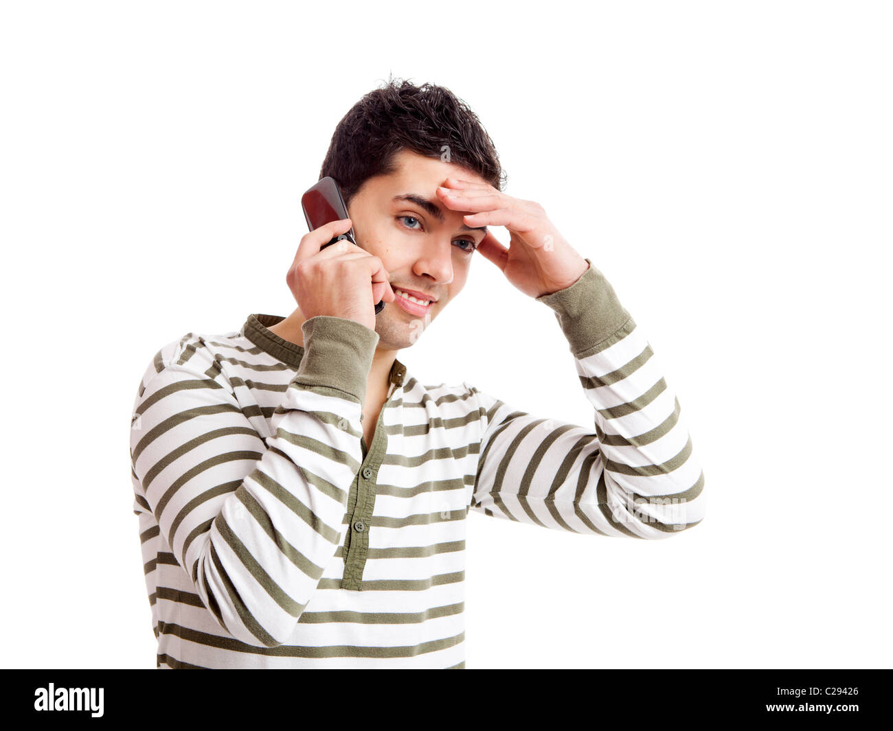 Handsome young man making a phone call with a forgotten expression ...