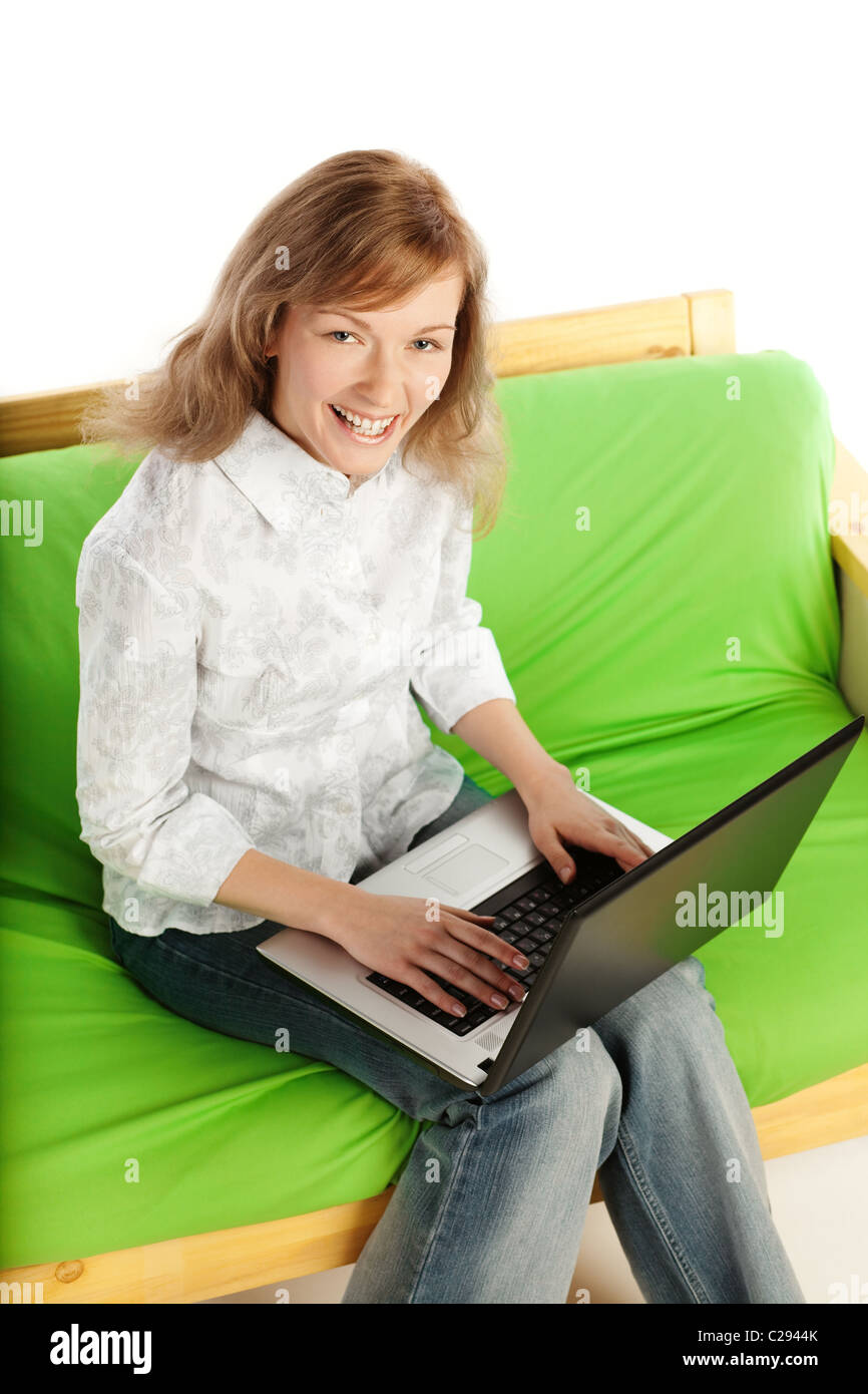 Happy young woman smiles while working with her laptop computer Stock ...