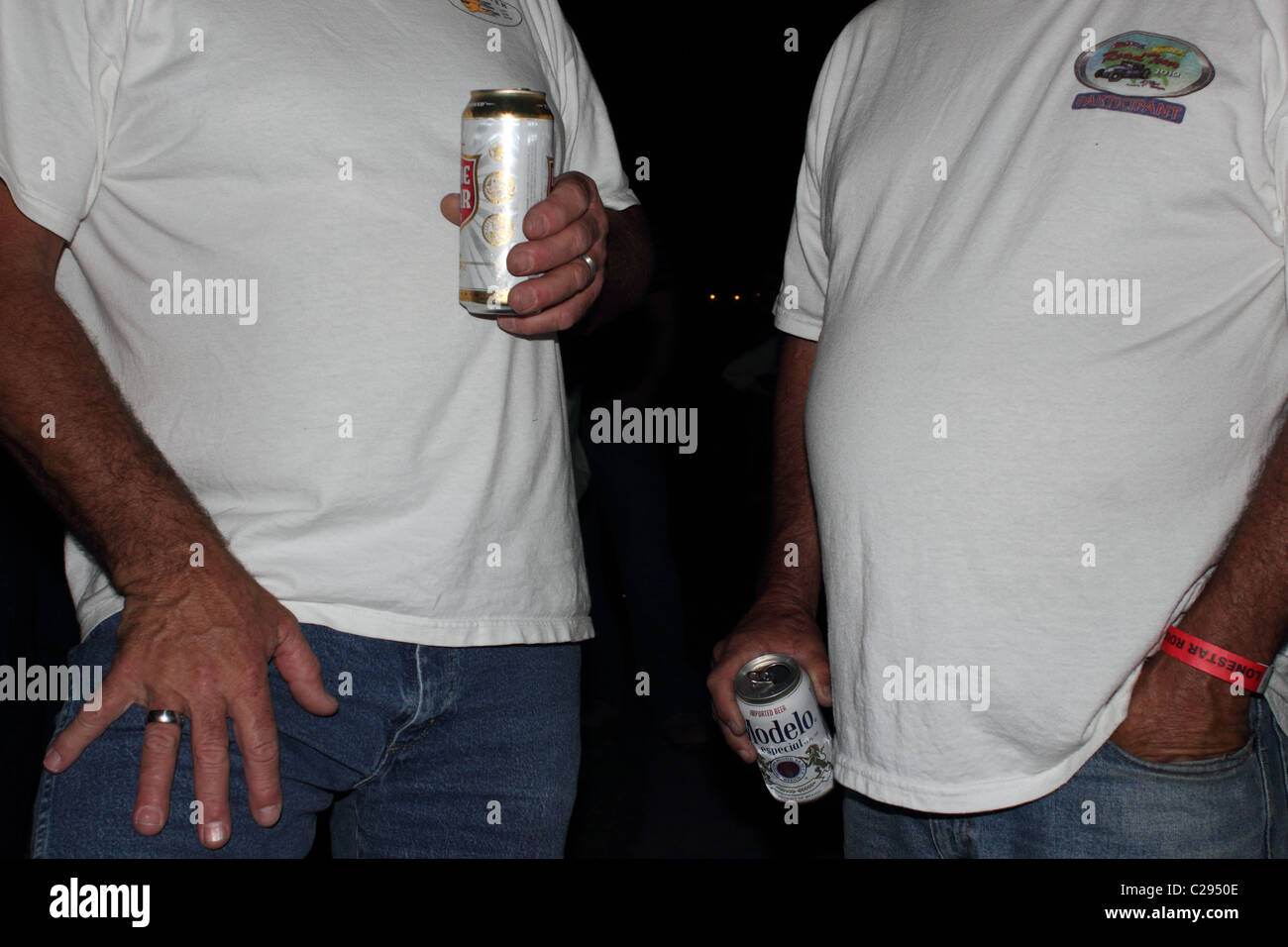 Two men holding cans of beer Stock Photo - Alamy