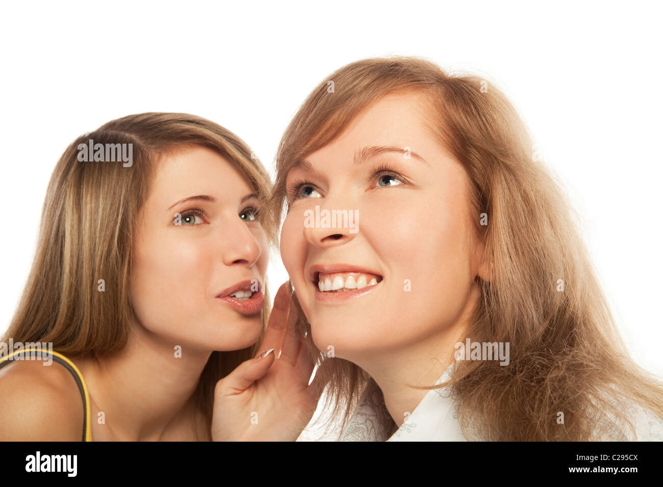 Two pretty blond girls whispering about their secrets; isolated on ...