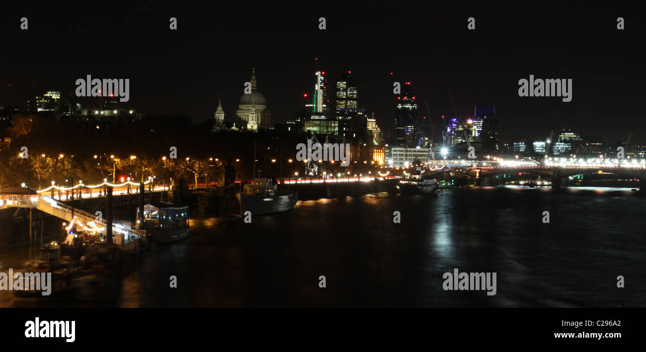 City of London waterfront reflected in River Thames at night London ...