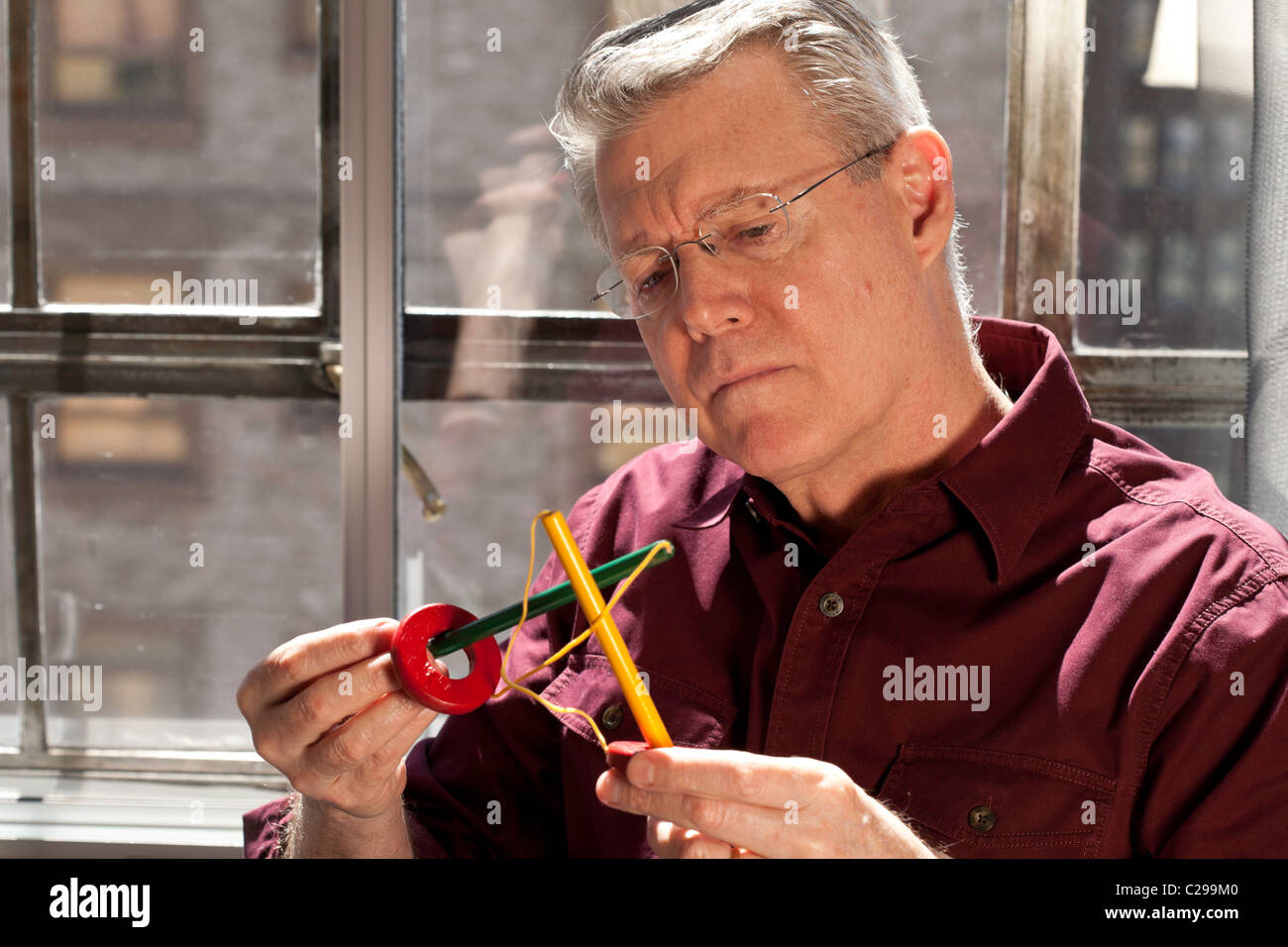 Mature Man Solving Logic Puzzle Stock Photo - Alamy