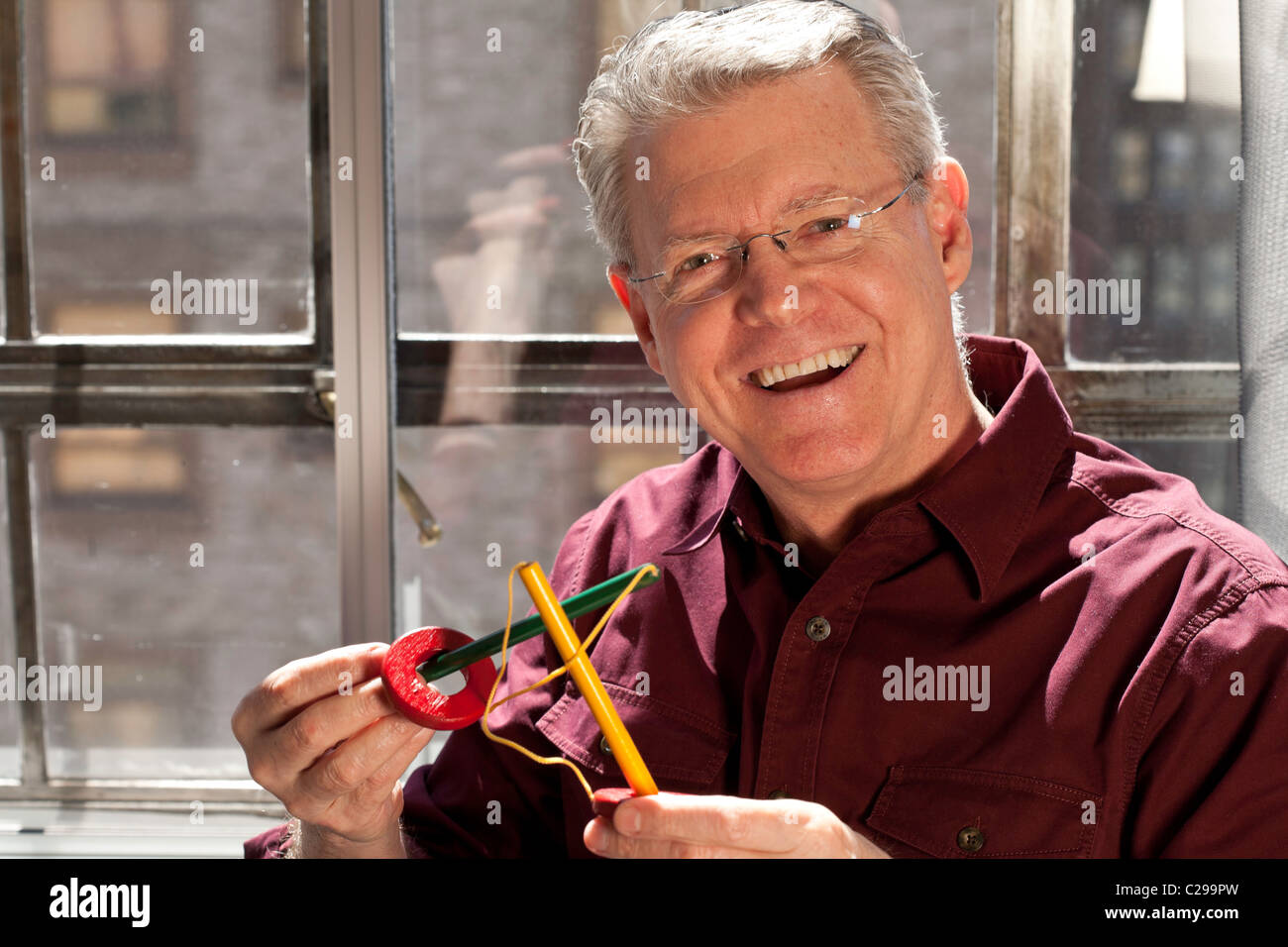 Mature Man Solving Logic Puzzle Stock Photo - Alamy