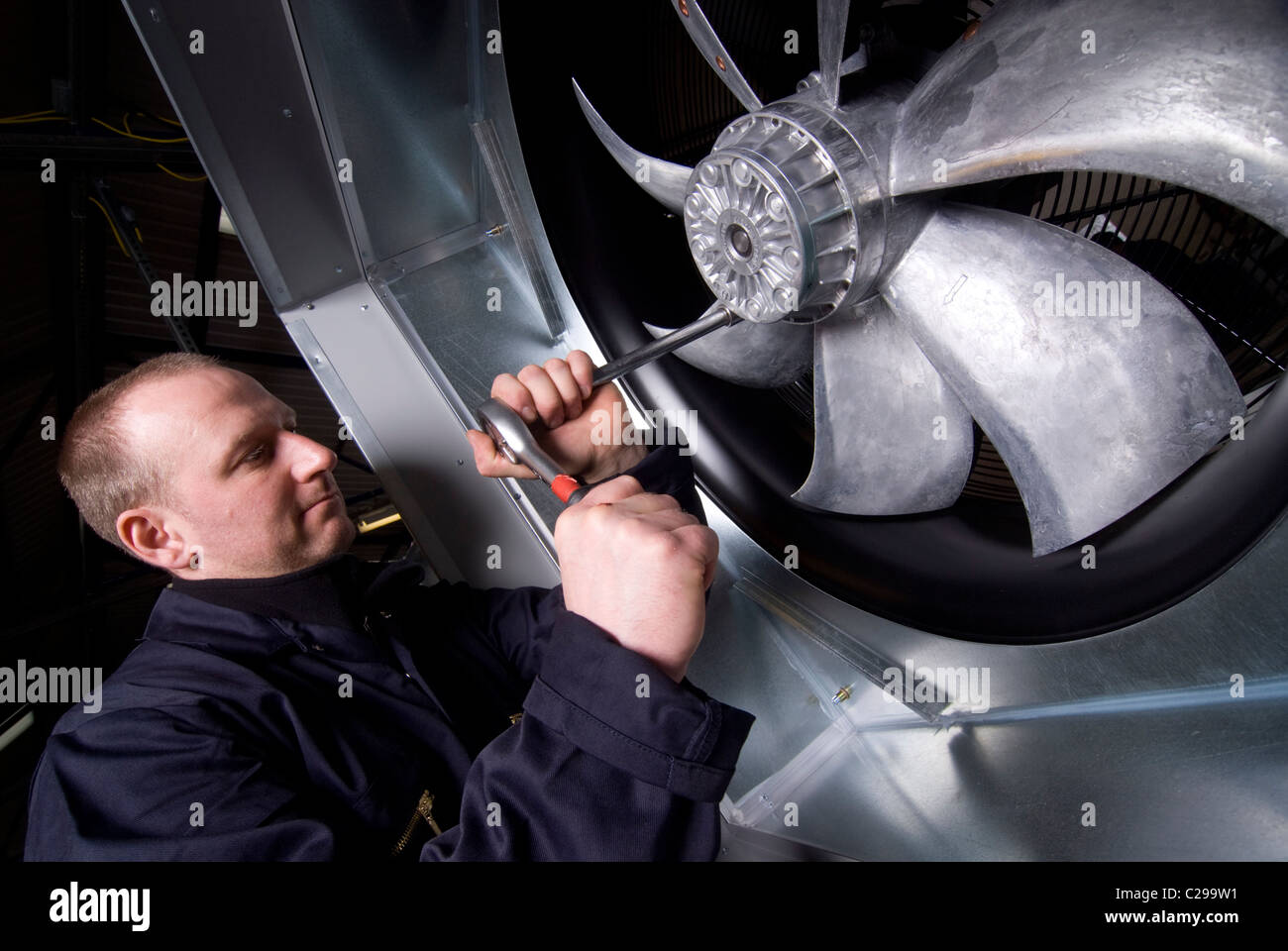 Engineer working on an industrial extractor fan Stock Photo - Alamy