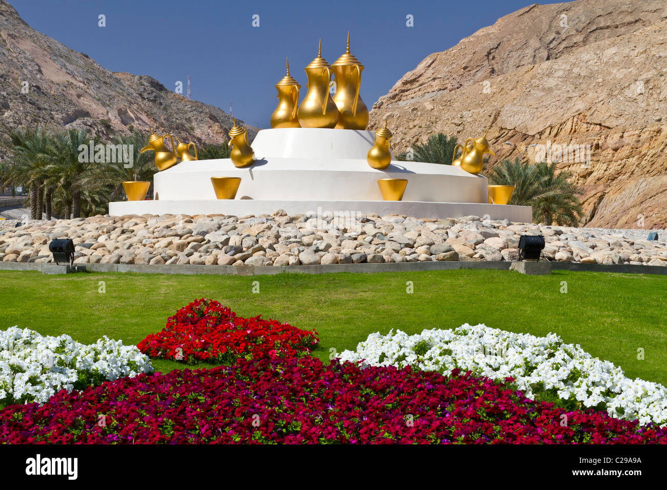 Decorative gold tea pots and flowers decorate a roundabout in Muscat ...