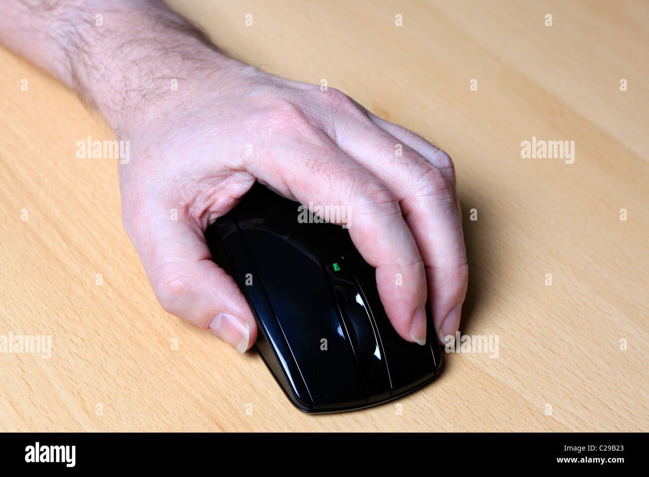 Hand using a modern WiFi cordless computer Mouse Stock Photo - Alamy