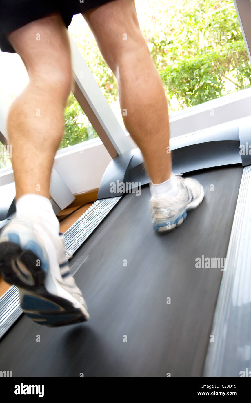 legs of a man running on a treadmill in a gym Stock Photo - Alamy
